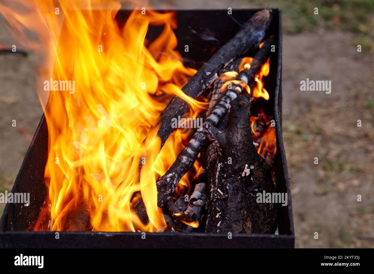 Burning red hot sparks fly from fire. Barbecue gril with glowing and ...