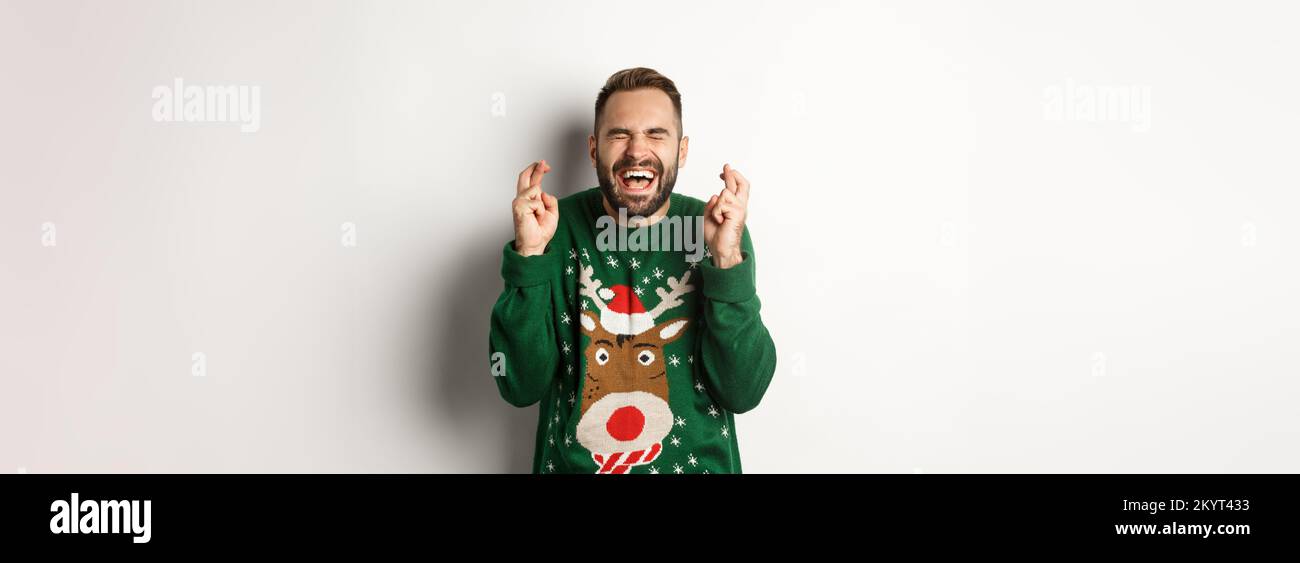 Christmas, holidays and celebration. Hopeful and excited guy making ...