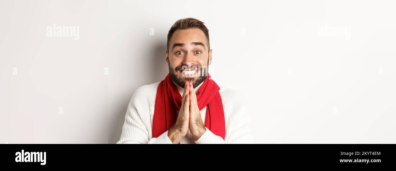 Christmas holidays. Close-up of beared man asking for favour, holding ...