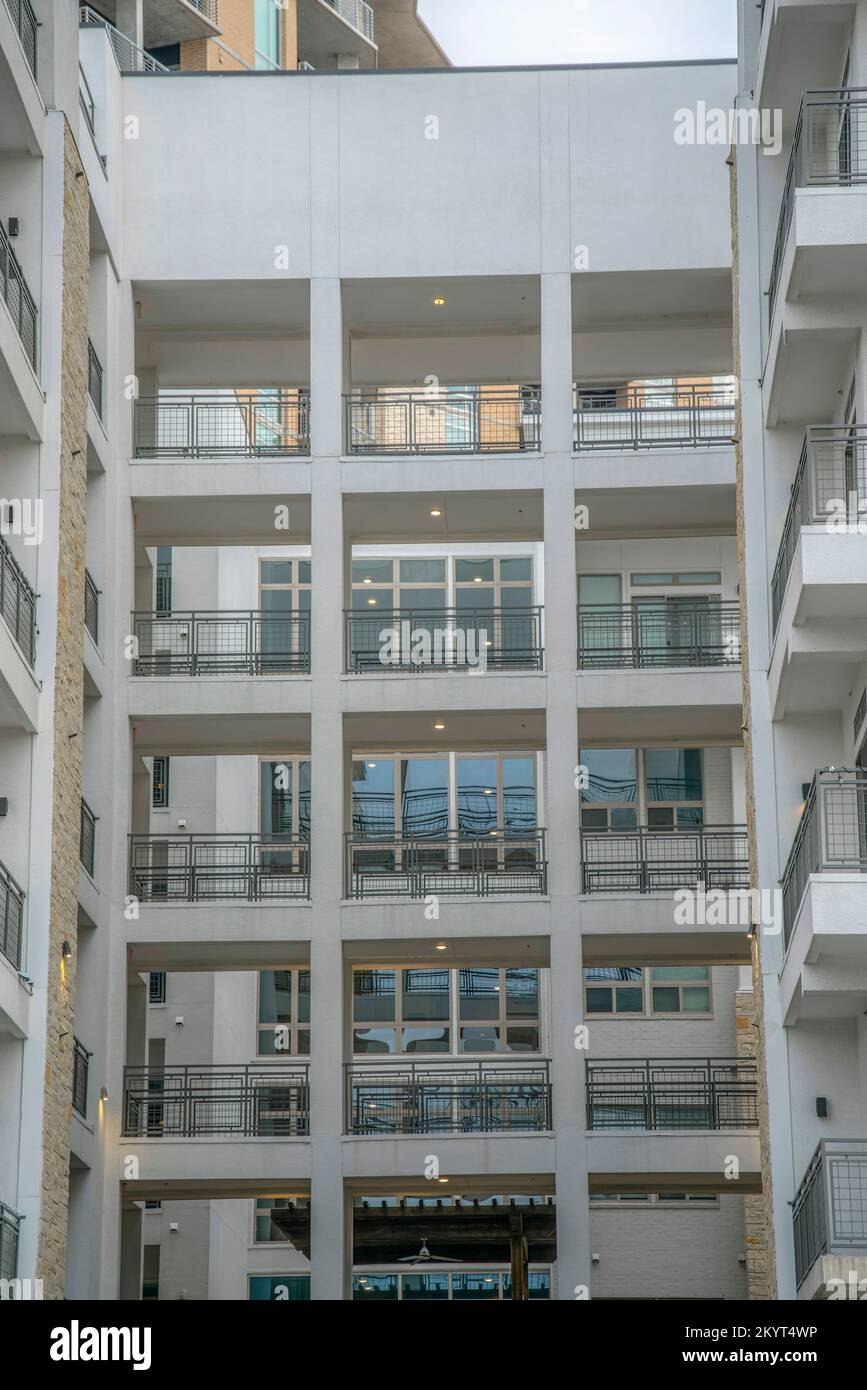 Multi storey apartment or office exterior with white wall and balconies ...