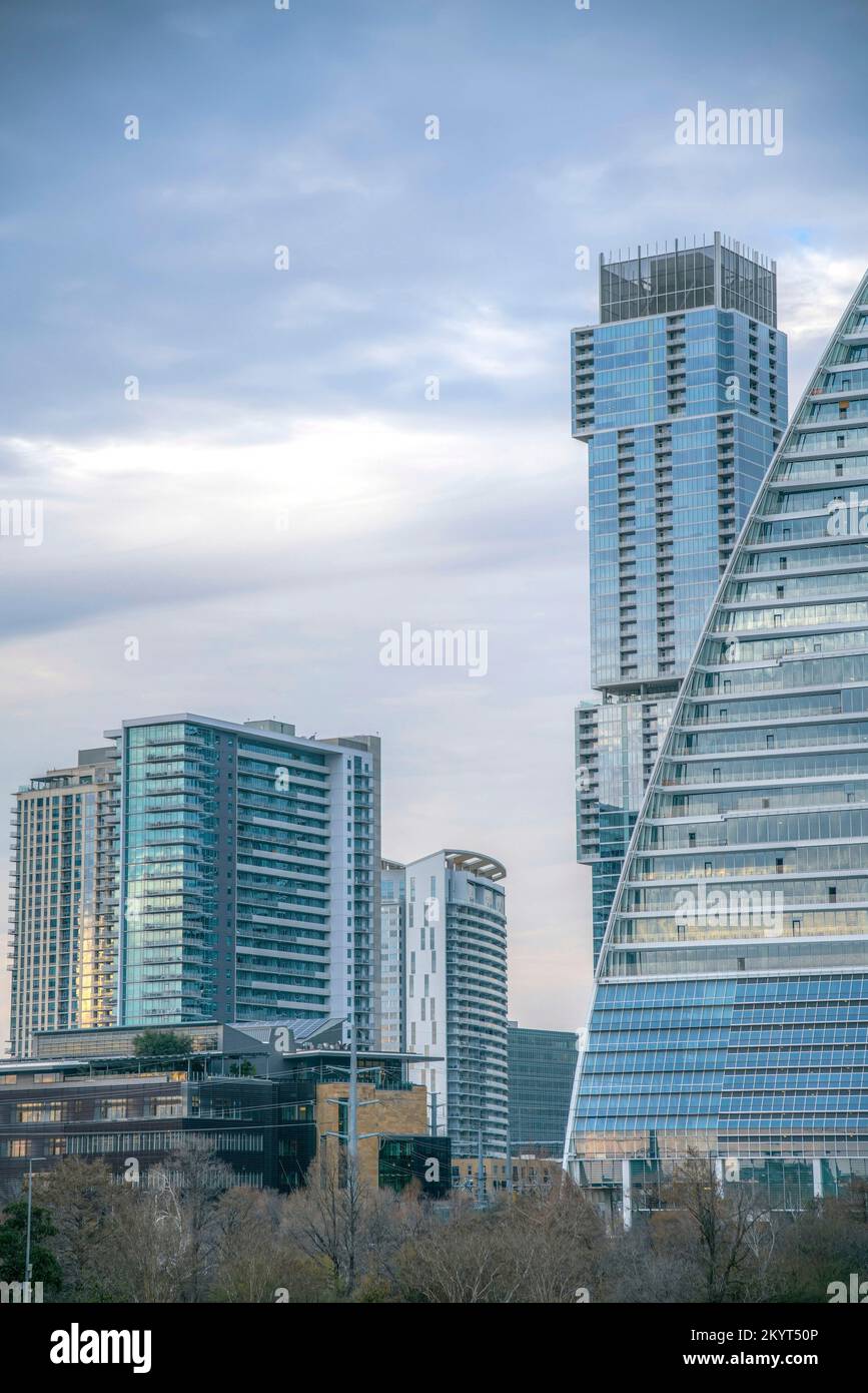 Residential and commercial glass buildings against cloudy sky in Austin ...