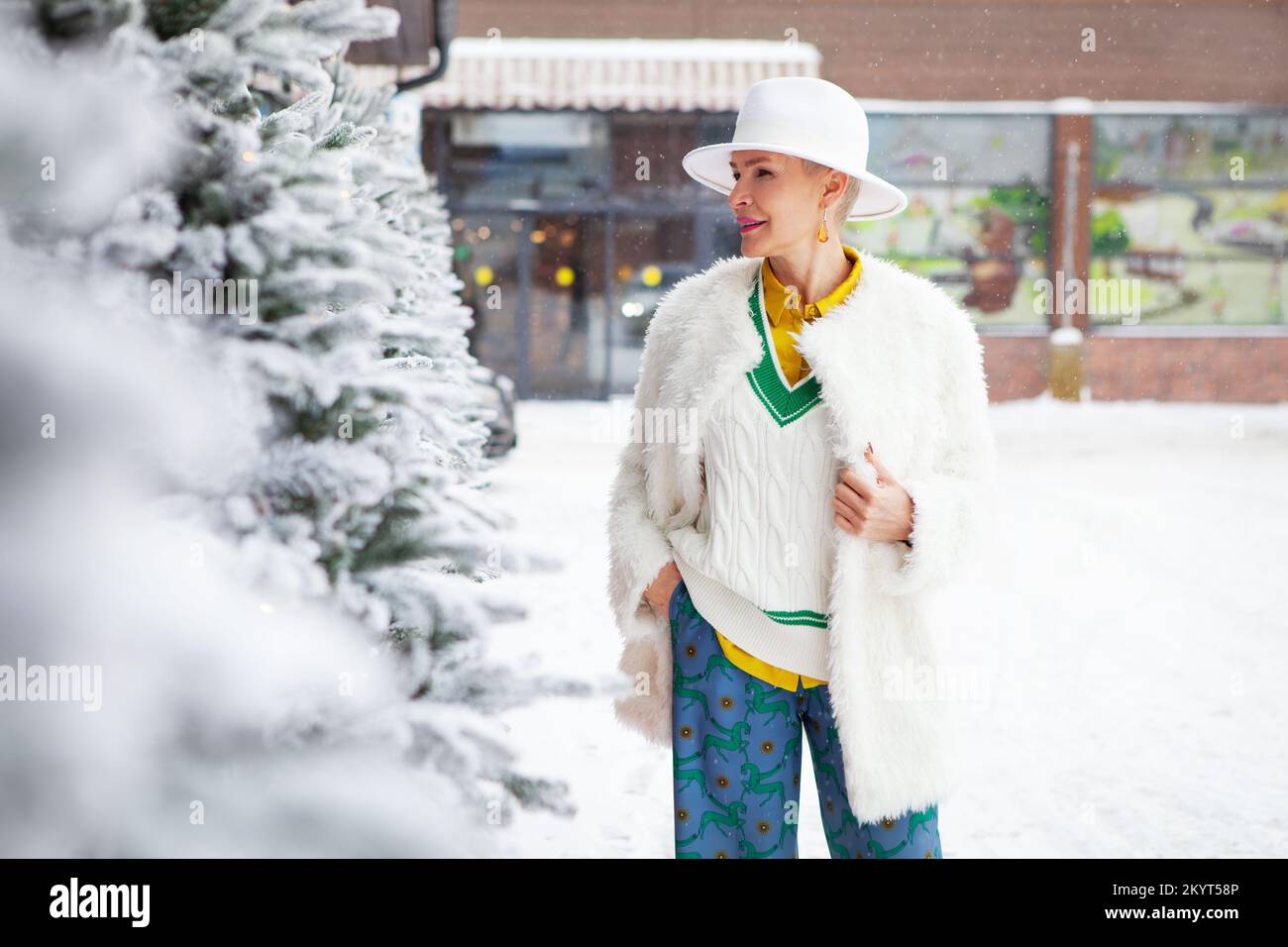 Winter bright fashion street style of middle age woman, wearing fedora ...