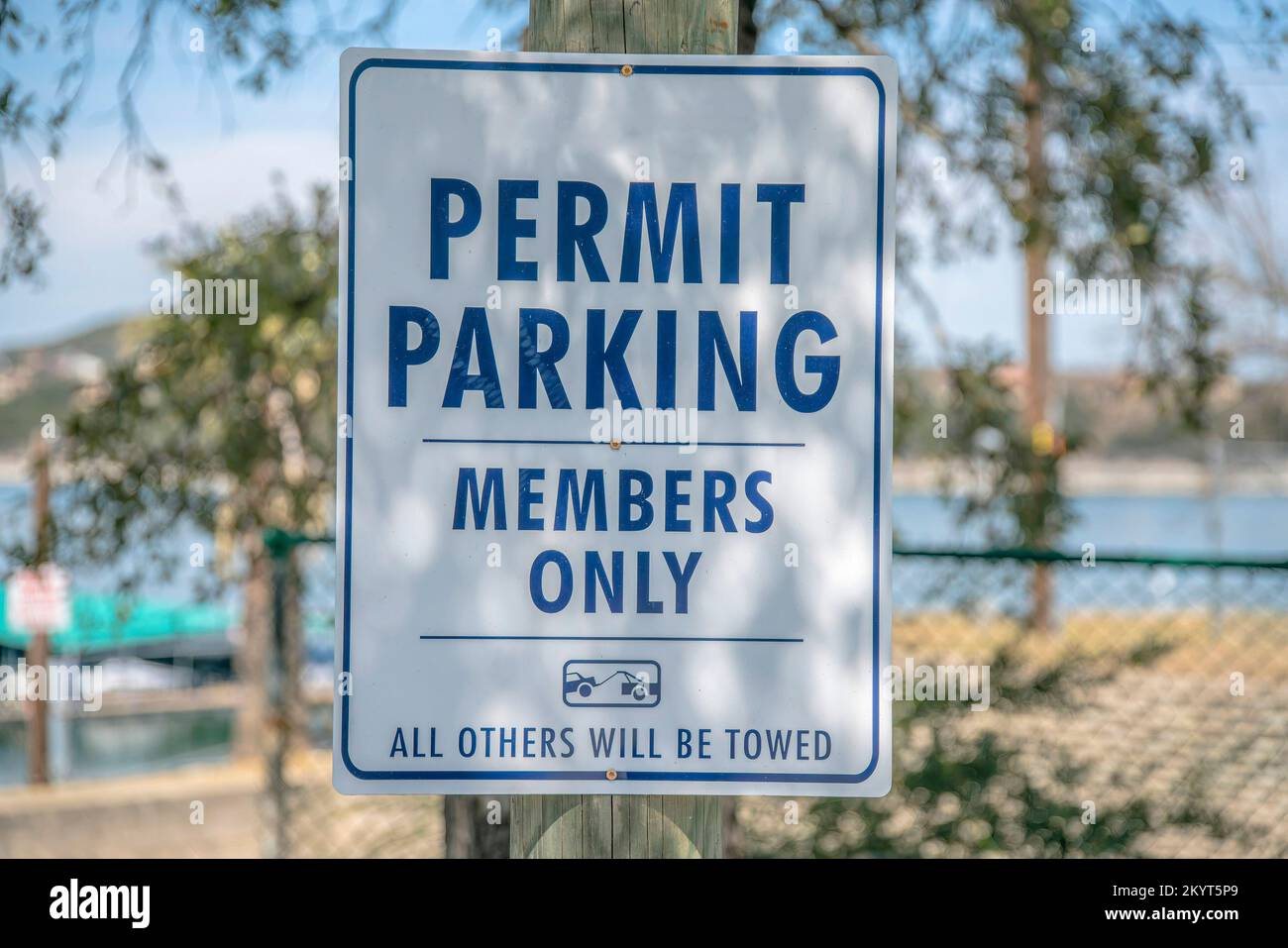 Permit Parking Members Only sign against blurry view of Lake Austin in ...