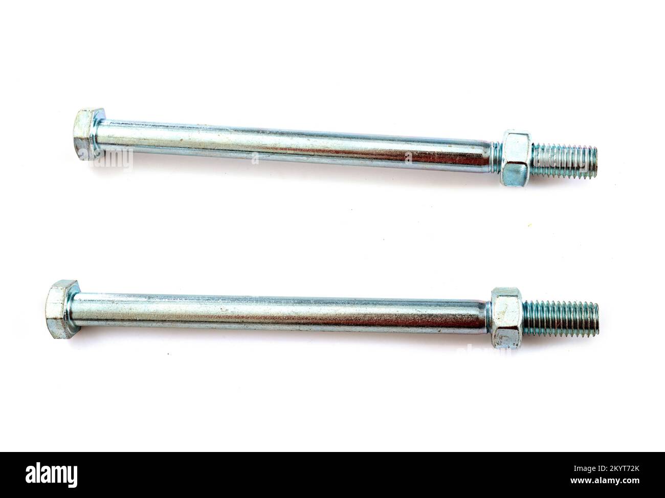 long nut and bolt in front of white background Stock Photo - Alamy