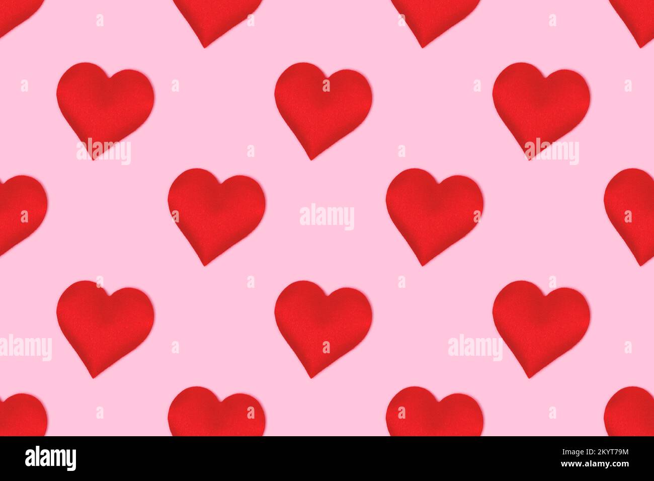 Repetitive pattern made of red hearts. Minimal concept on a pink ...