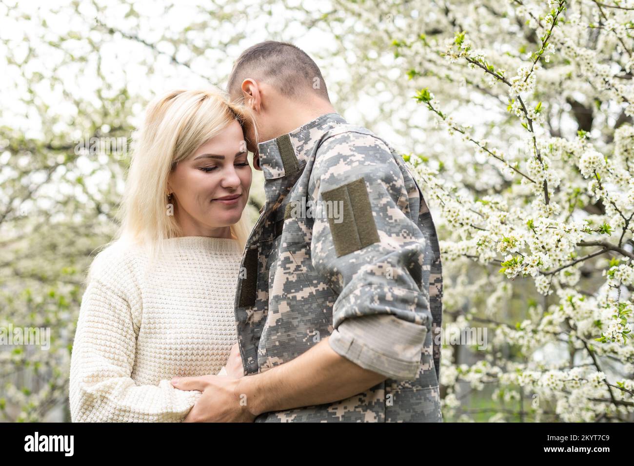 Soldier reunited with wife in park Stock Photo - Alamy