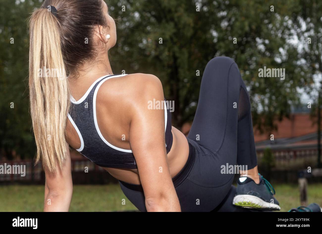 Sporty woman exercising outside in the city park. Beautiful female ...