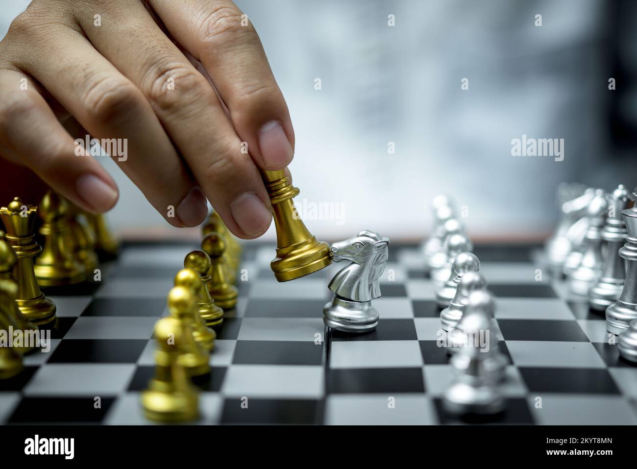 hand of businessman moving chess figure in competition success play ...