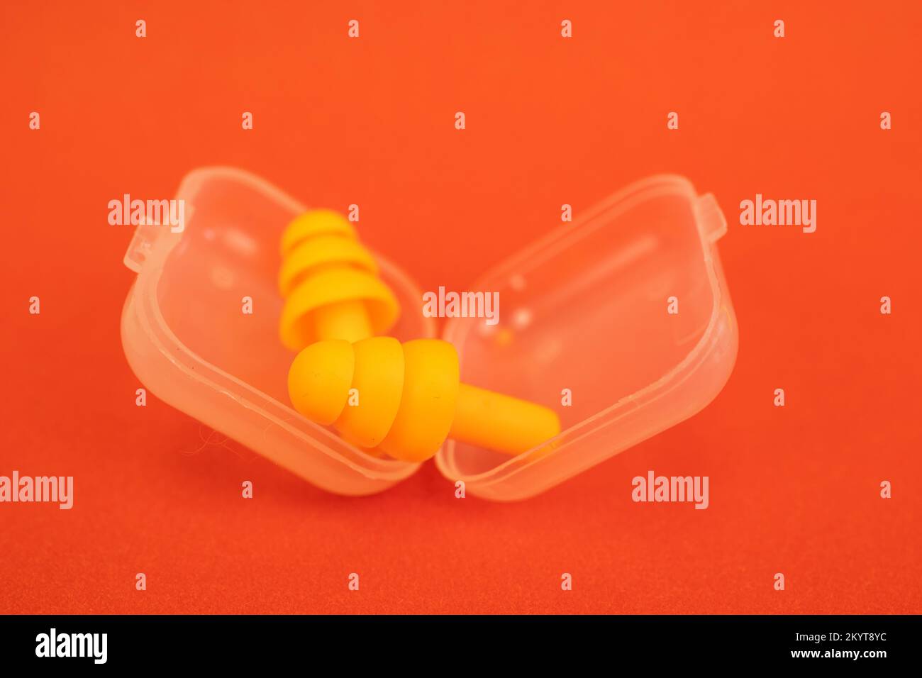 Silicone ear plugs for human ears on red background Stock Photo - Alamy