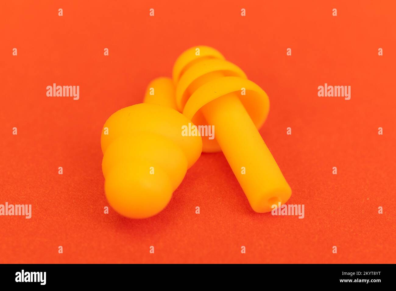 Silicone ear plugs for human ears on red background Stock Photo - Alamy