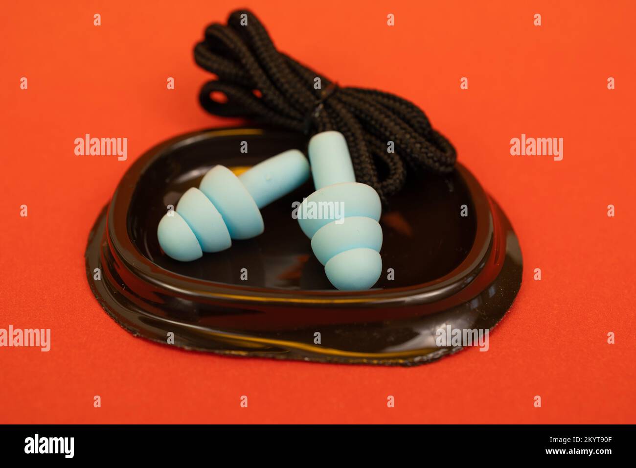 Silicone ear plugs for human ears on red background Stock Photo - Alamy