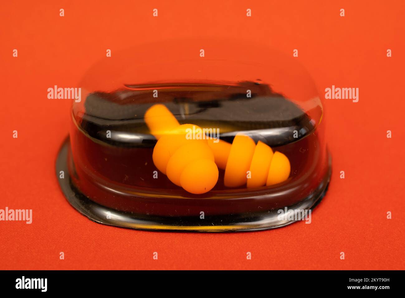 Silicone ear plugs for human ears on red background Stock Photo - Alamy
