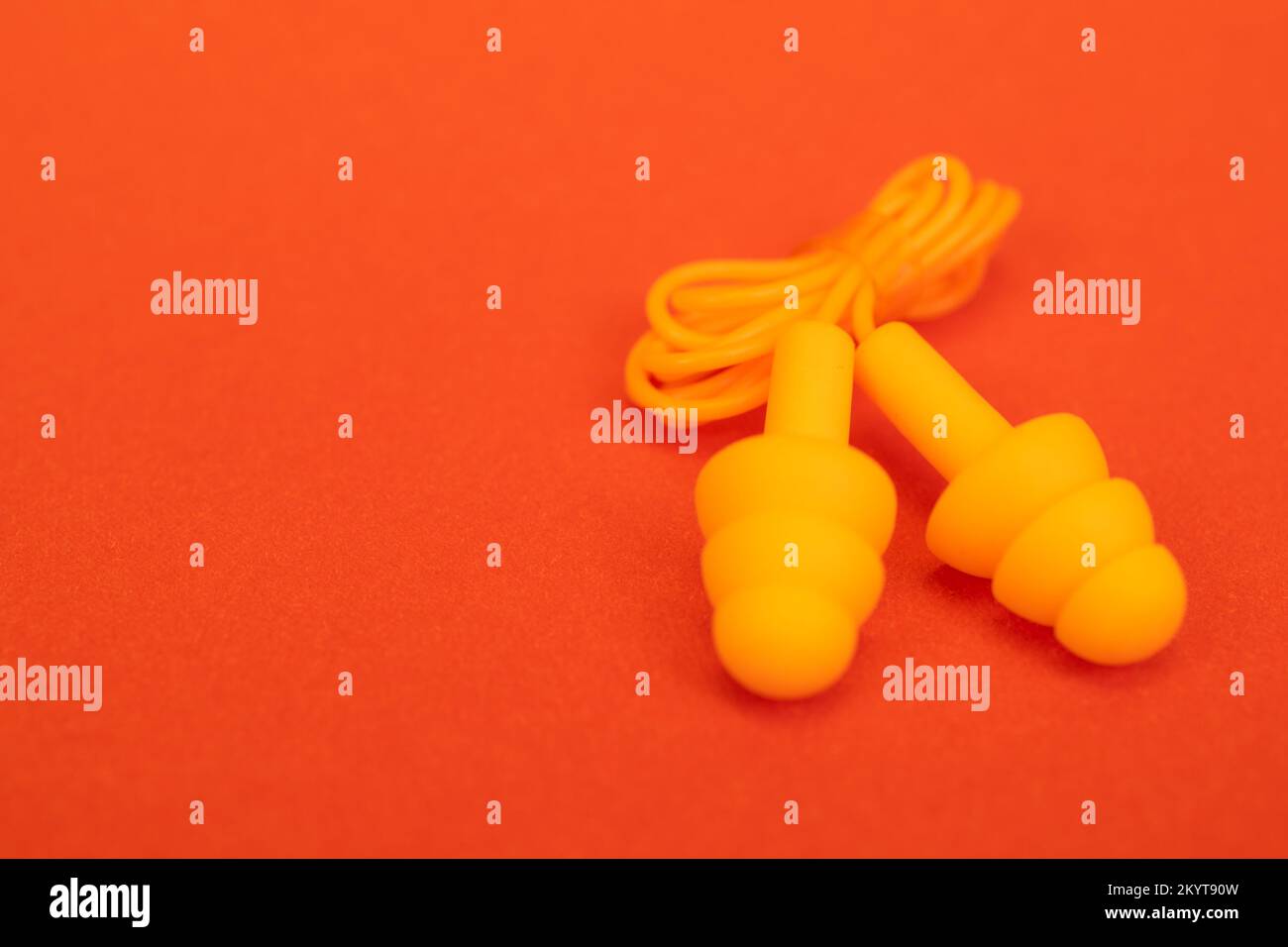 Silicone ear plugs for human ears on red background Stock Photo - Alamy