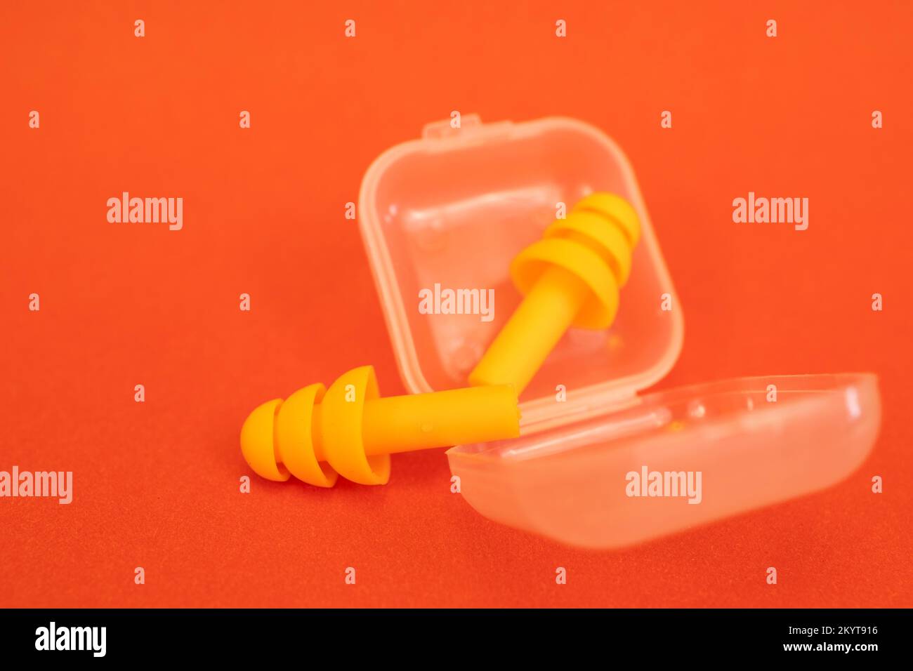 Silicone ear plugs for human ears on red background Stock Photo - Alamy