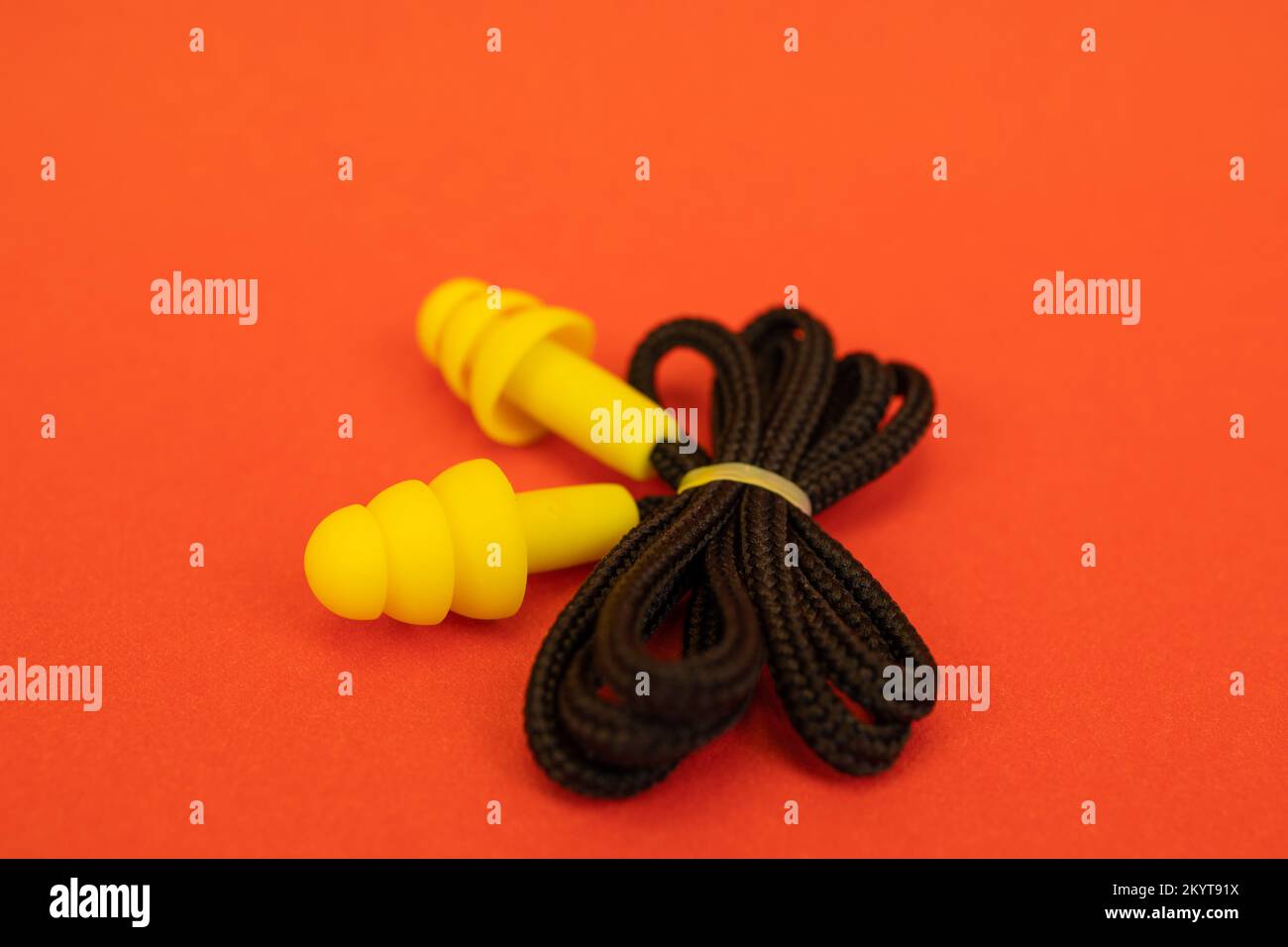Silicone ear plugs for human ears on red background Stock Photo - Alamy