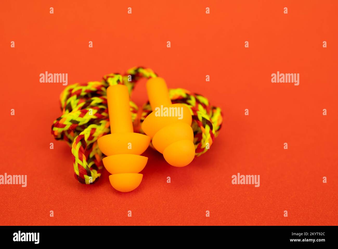 Silicone ear plugs for human ears on red background Stock Photo - Alamy