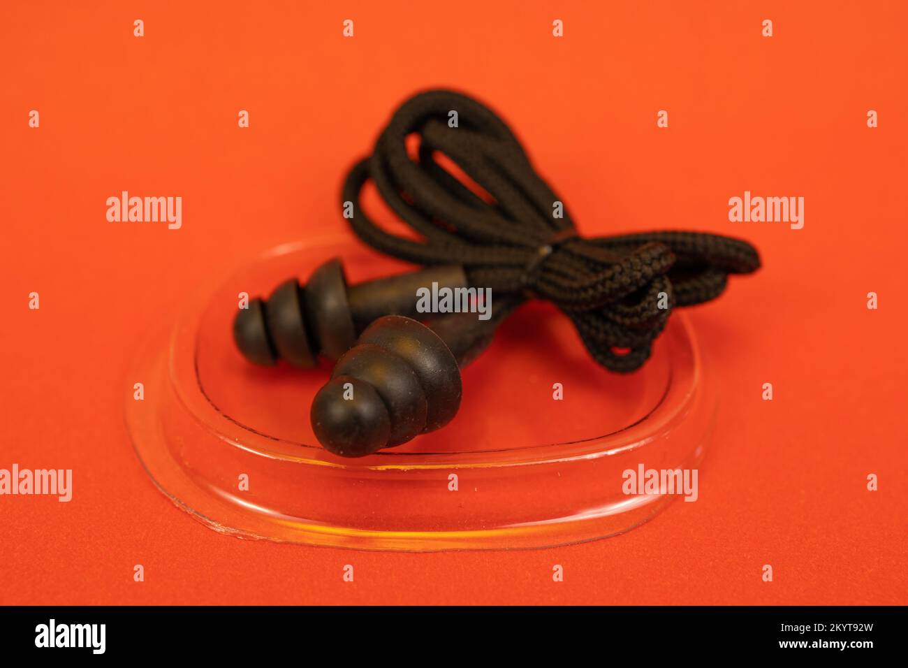 Silicone ear plugs for human ears on red background Stock Photo - Alamy