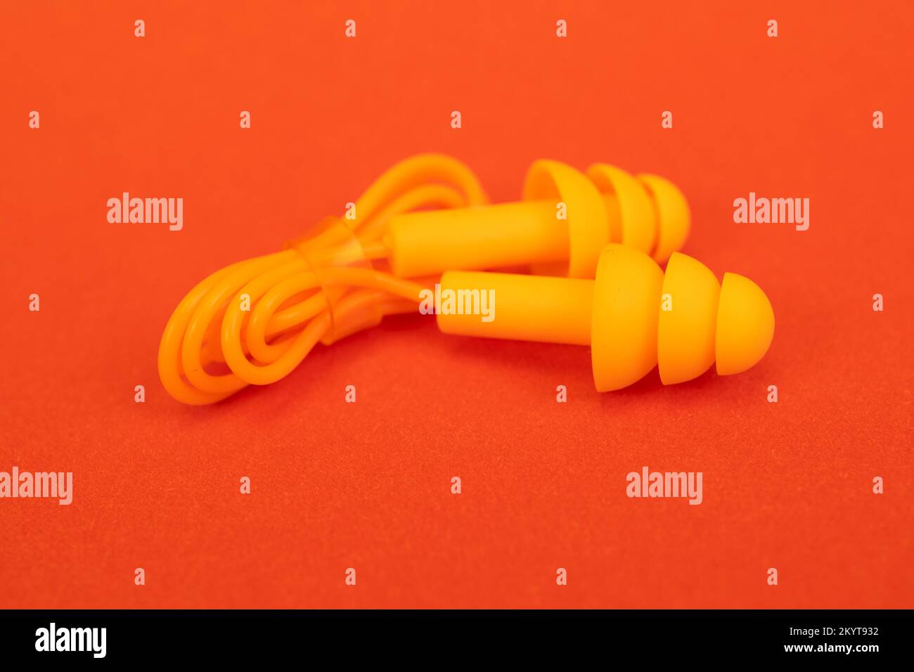 Silicone ear plugs for human ears on red background Stock Photo - Alamy