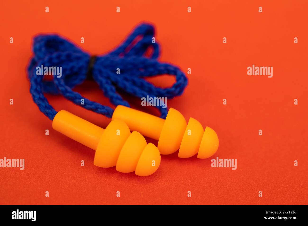 Silicone ear plugs for human ears on red background Stock Photo - Alamy