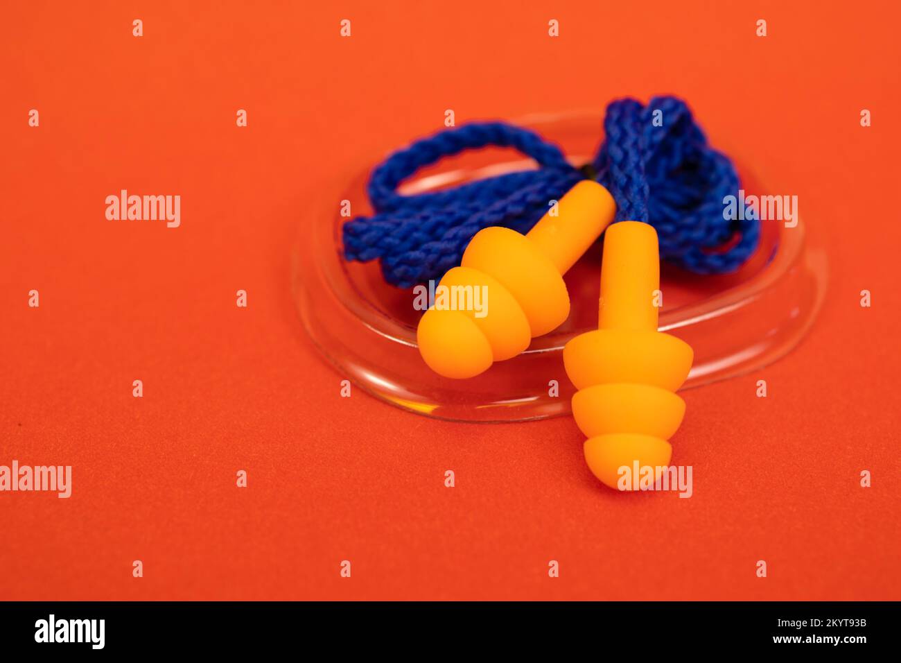 Silicone ear plugs for human ears on red background Stock Photo - Alamy