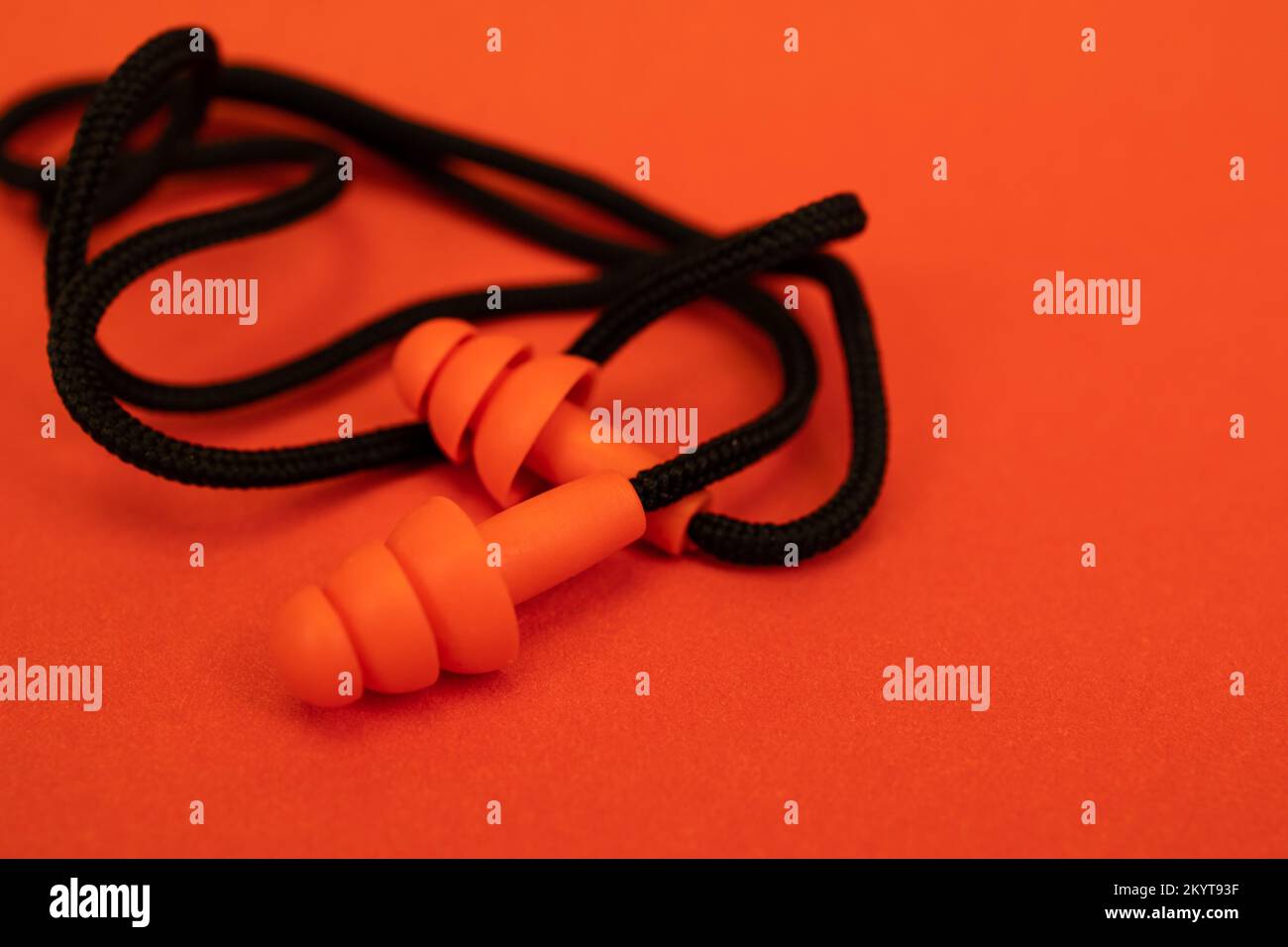 Silicone ear plugs for human ears on red background Stock Photo - Alamy