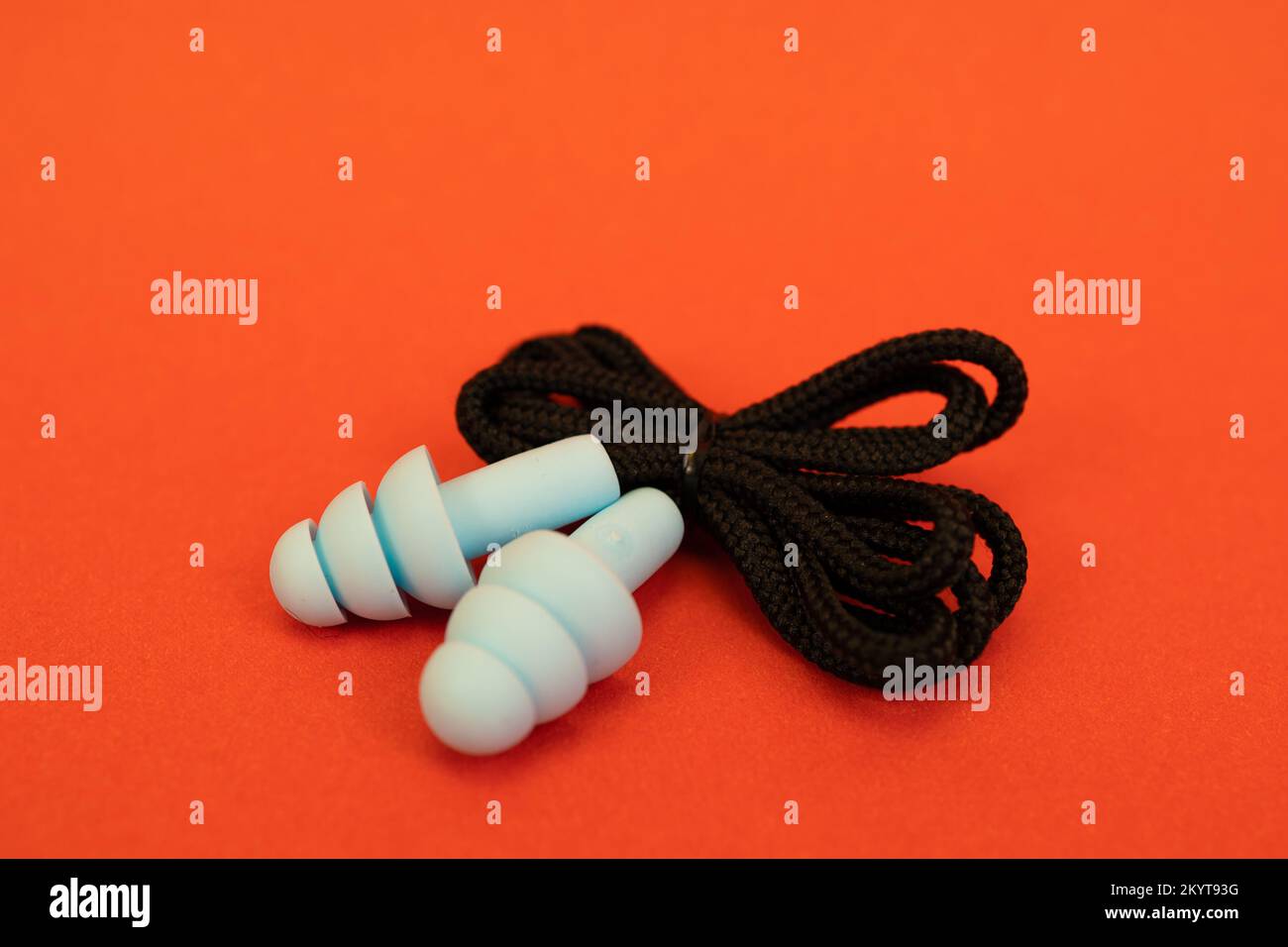 Silicone ear plugs for human ears on red background Stock Photo - Alamy