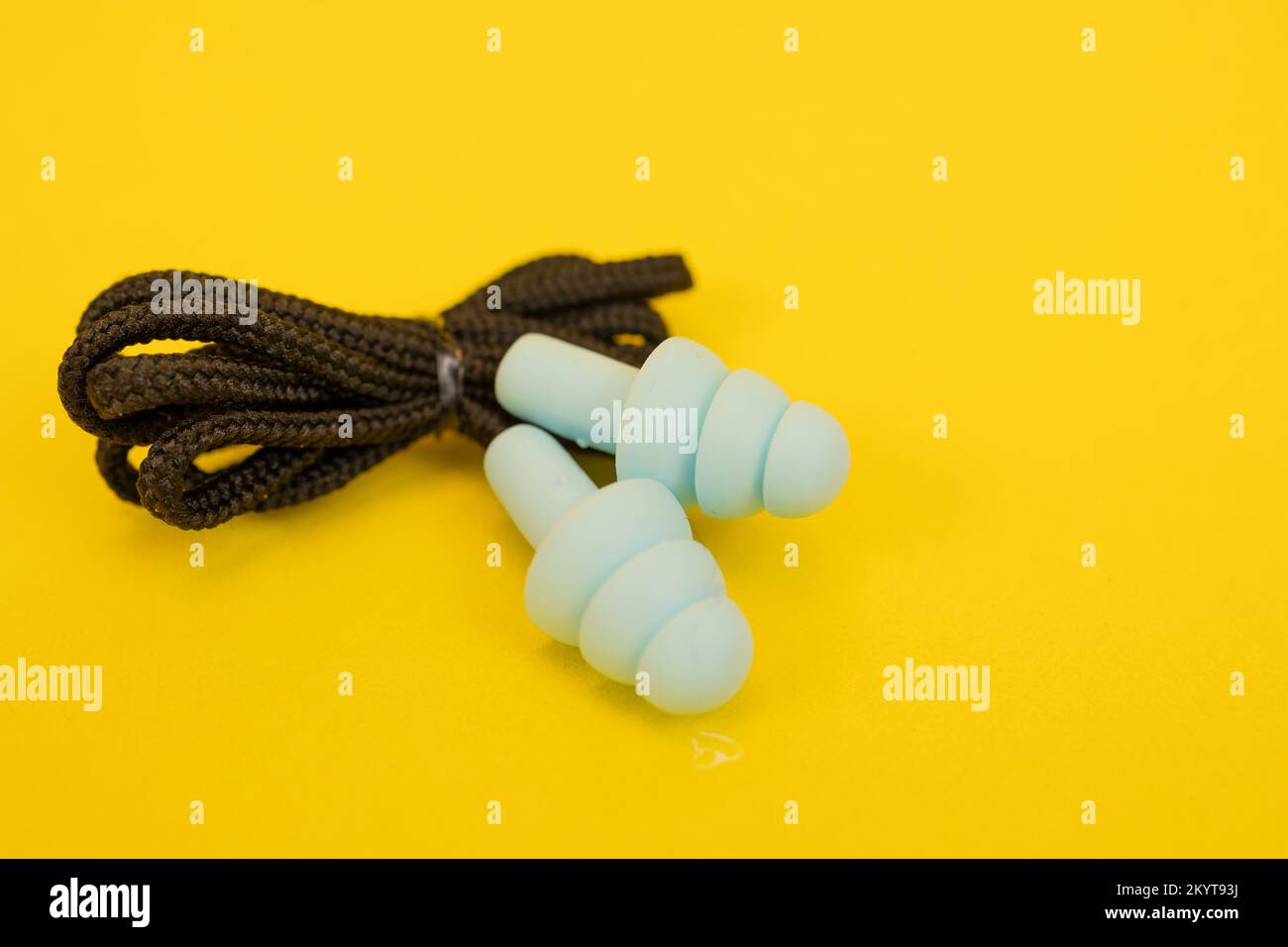 Silicone ear plugs for human ears on yellow background Stock Photo - Alamy