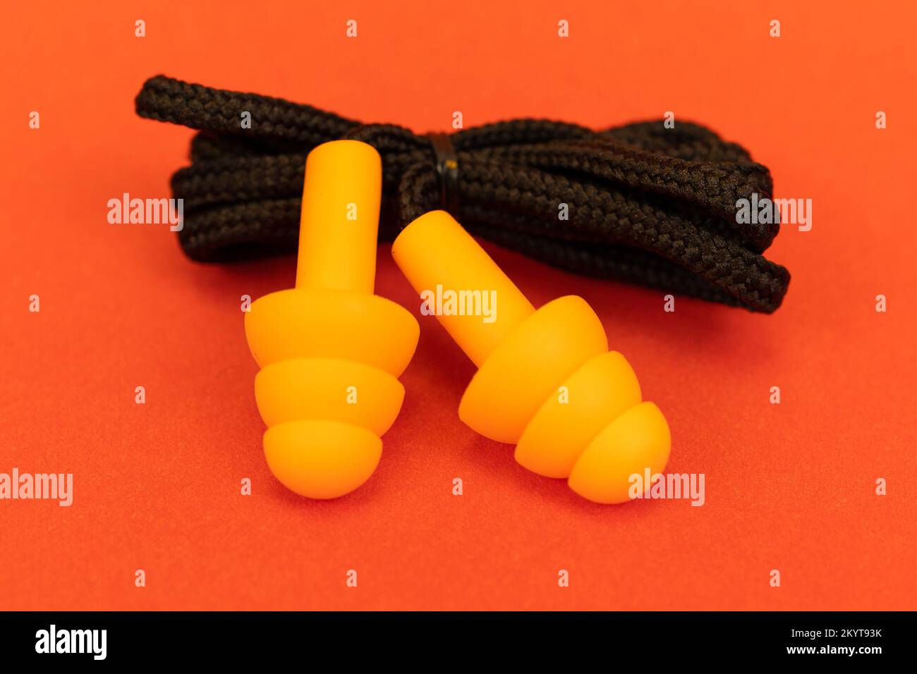 Silicone ear plugs for human ears on red background Stock Photo - Alamy