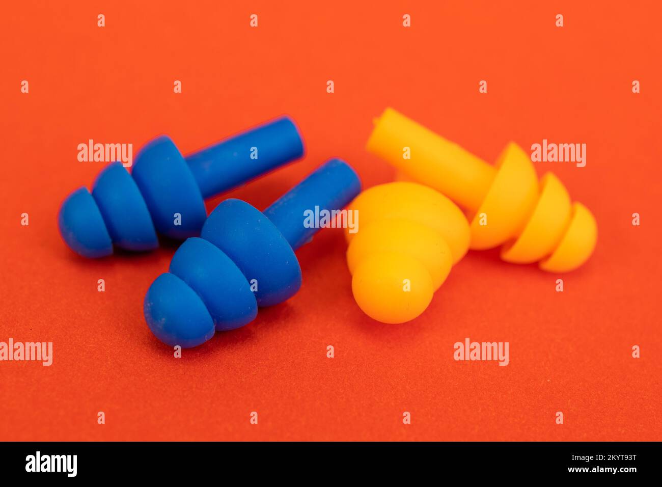 Silicone ear plugs for human ears on red background Stock Photo - Alamy