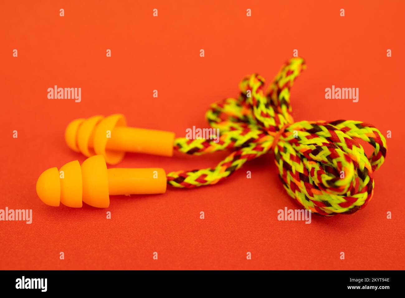 Silicone ear plugs for human ears on red background Stock Photo - Alamy