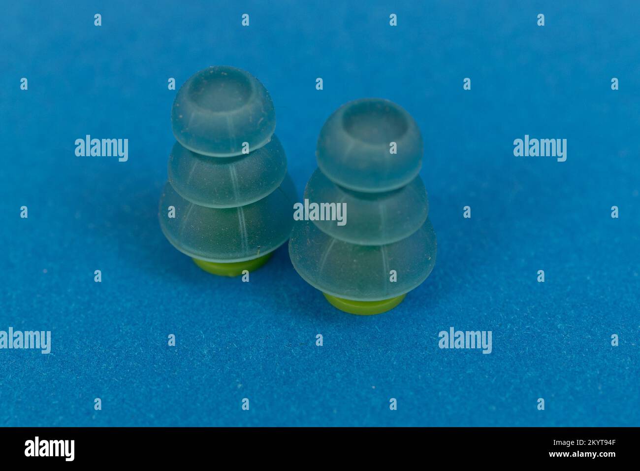 Silicone ear plugs for human ears on blue background Stock Photo - Alamy