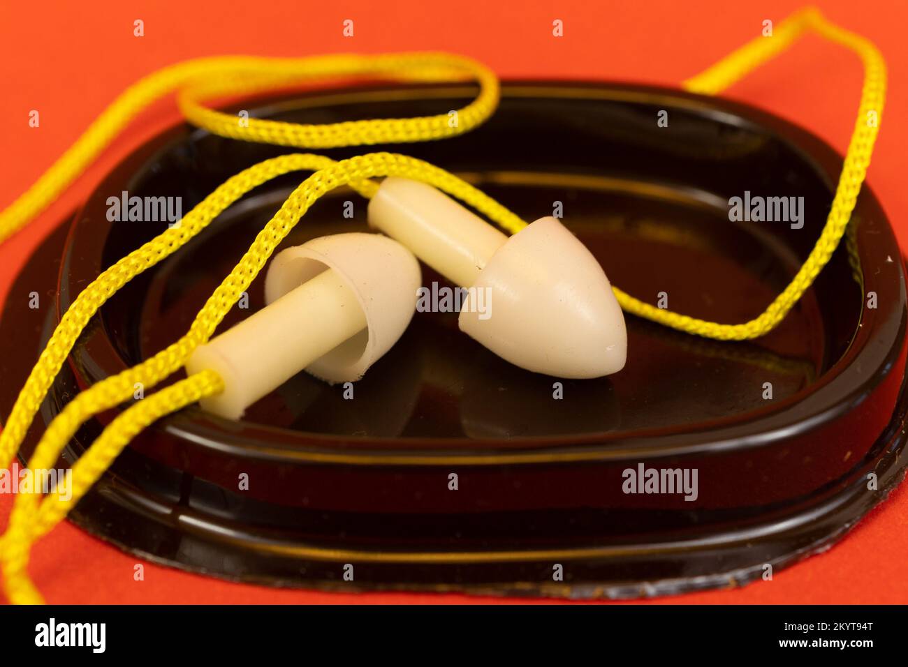 Silicone ear plugs for human ears on red background Stock Photo - Alamy