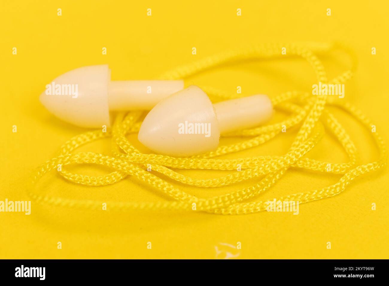 Silicone ear plugs for human ears on yellow background Stock Photo - Alamy