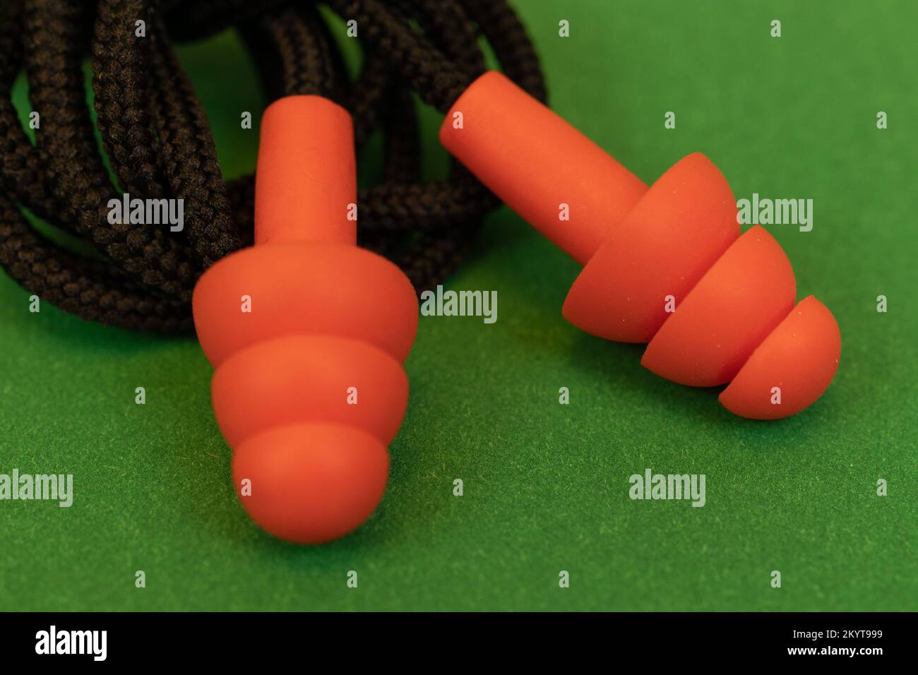 Silicone reusable ear plugs for human ears on green background Stock ...