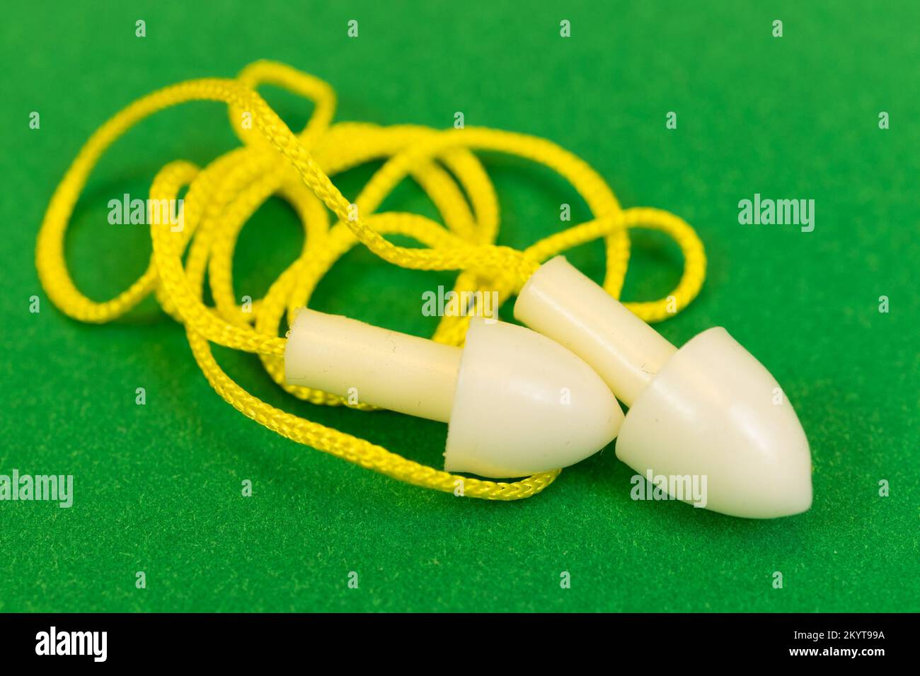 Silicone reusable ear plugs for human ears on green background Stock ...