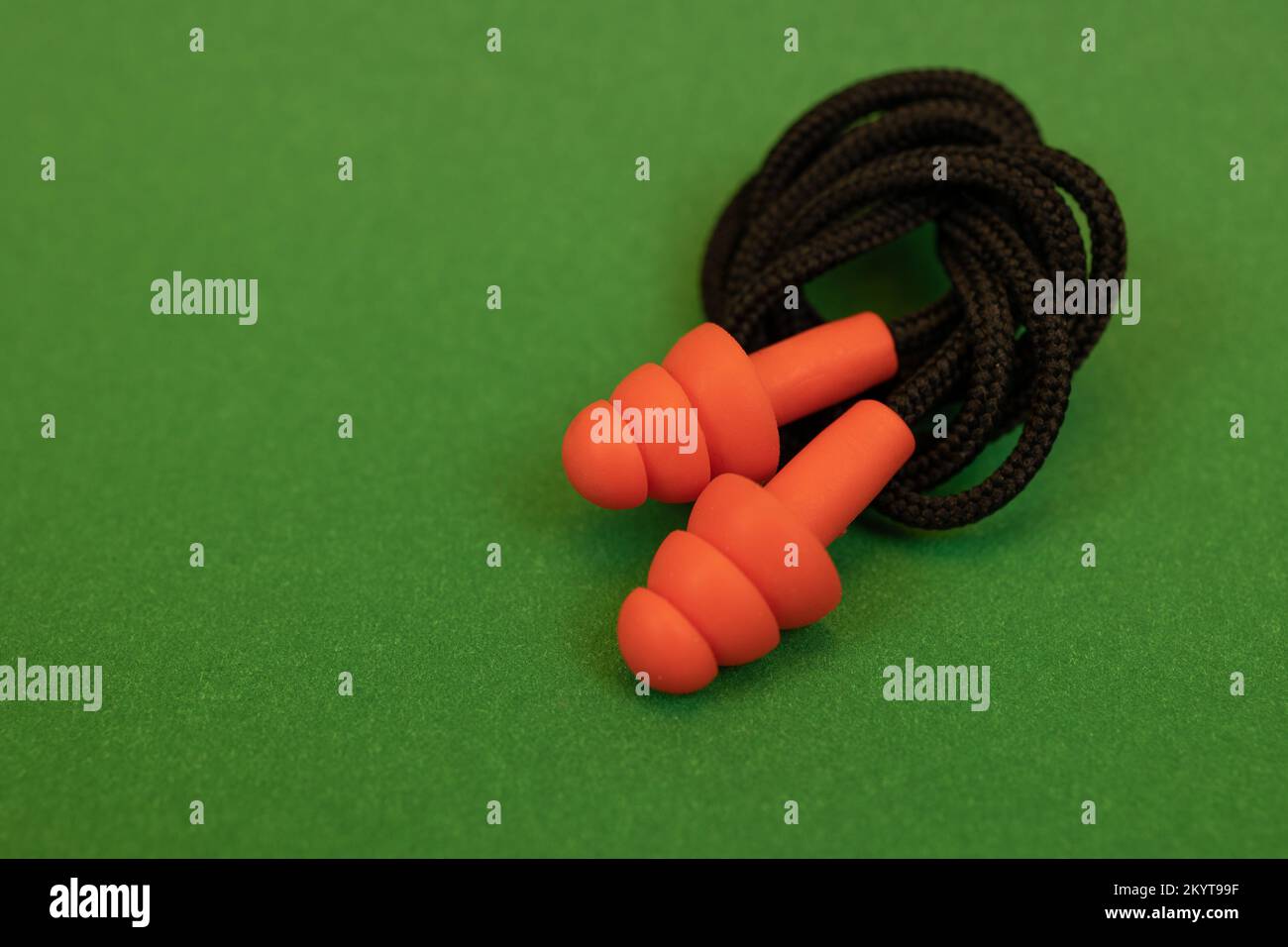Silicone reusable ear plugs for human ears on green background Stock ...