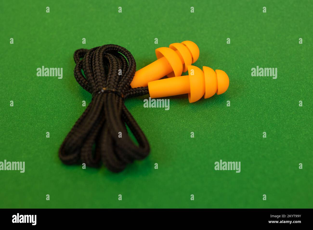 Silicone reusable ear plugs for human ears on green background Stock ...