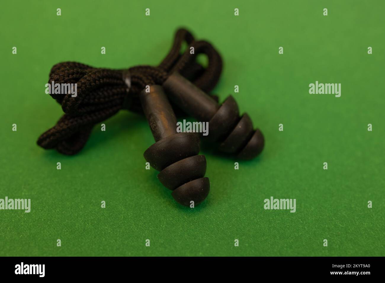 Silicone reusable ear plugs for human ears on green background Stock ...