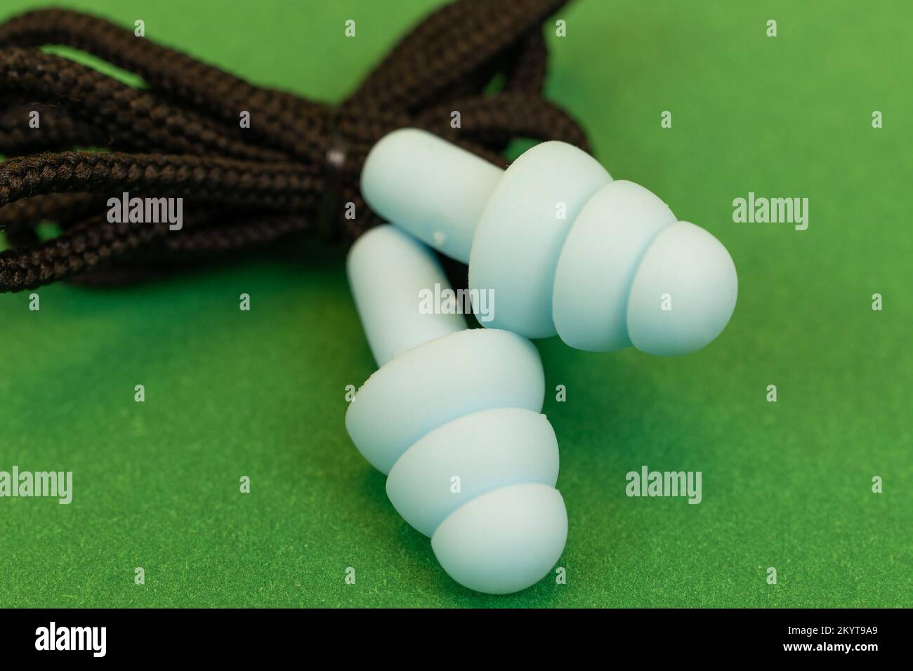 Silicone reusable ear plugs for human ears on green background Stock ...