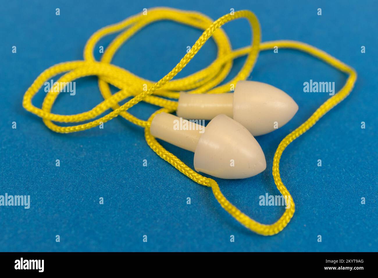 Silicone ear plugs for human ears on blue background Stock Photo - Alamy