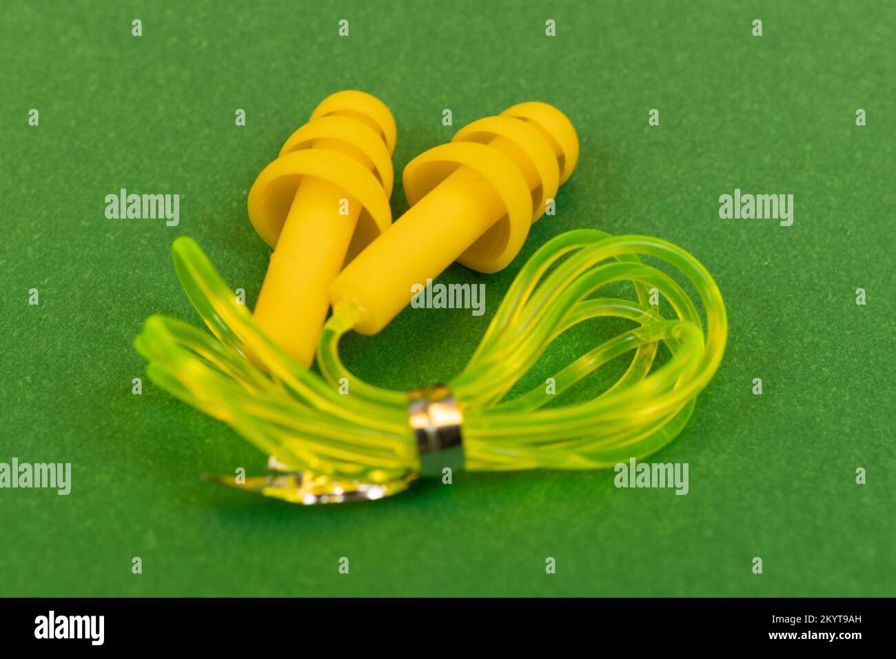 Silicone reusable ear plugs for human ears on green background Stock ...
