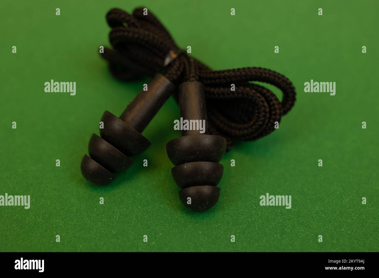 Silicone reusable ear plugs for human ears on green background Stock ...