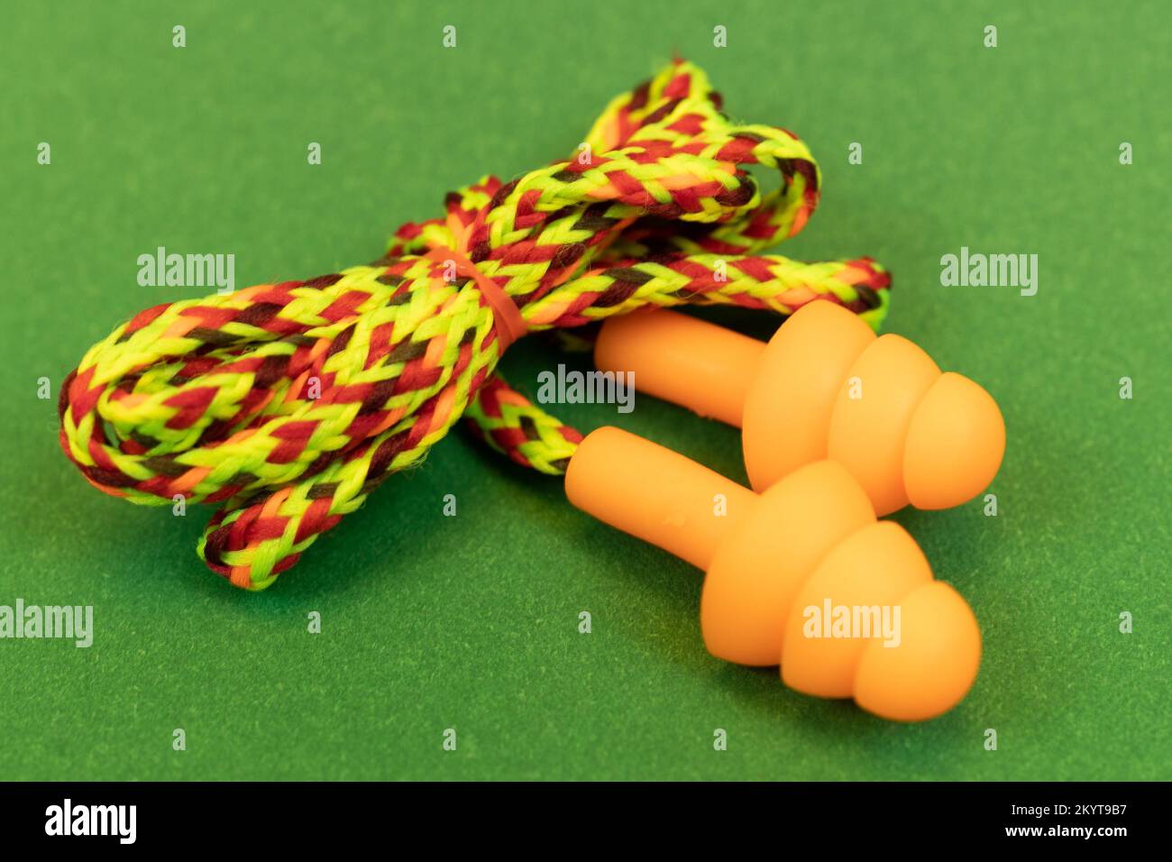 Silicone reusable ear plugs for human ears on green background Stock ...