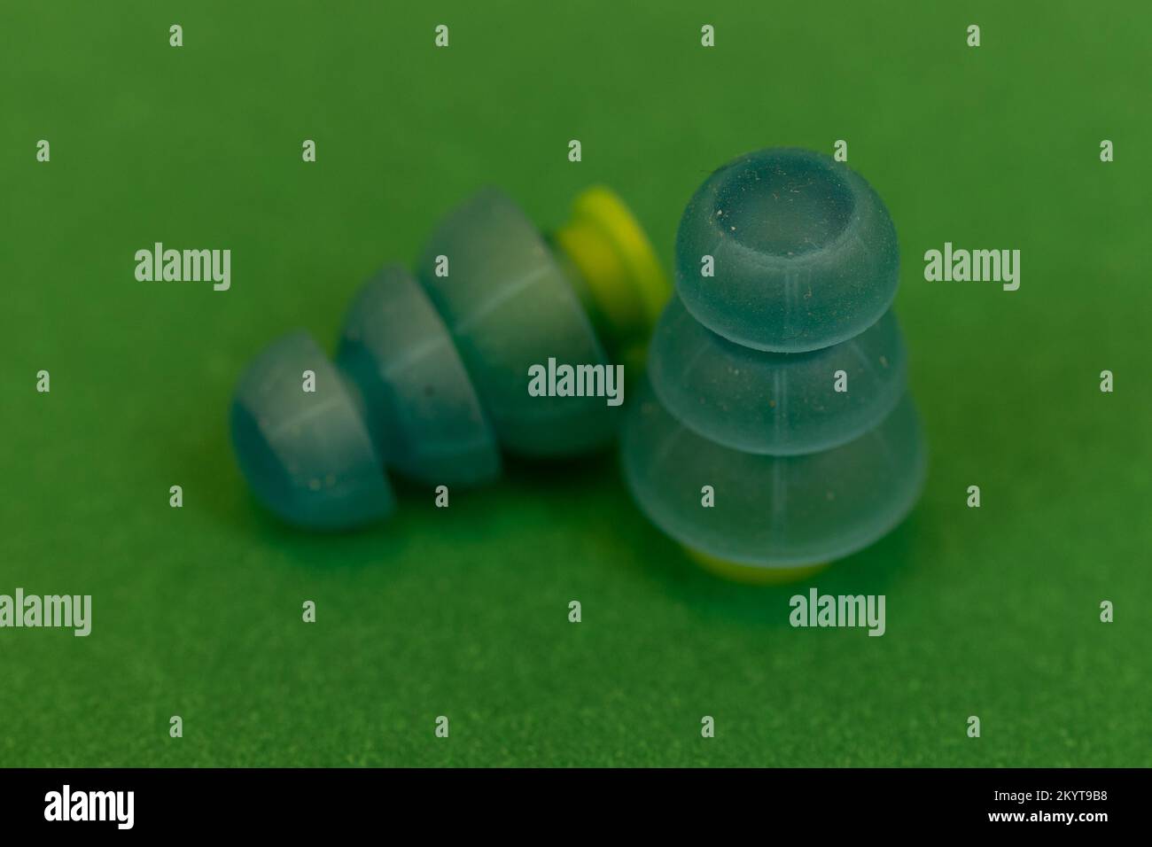 Silicone reusable ear plugs for human ears on green background Stock ...