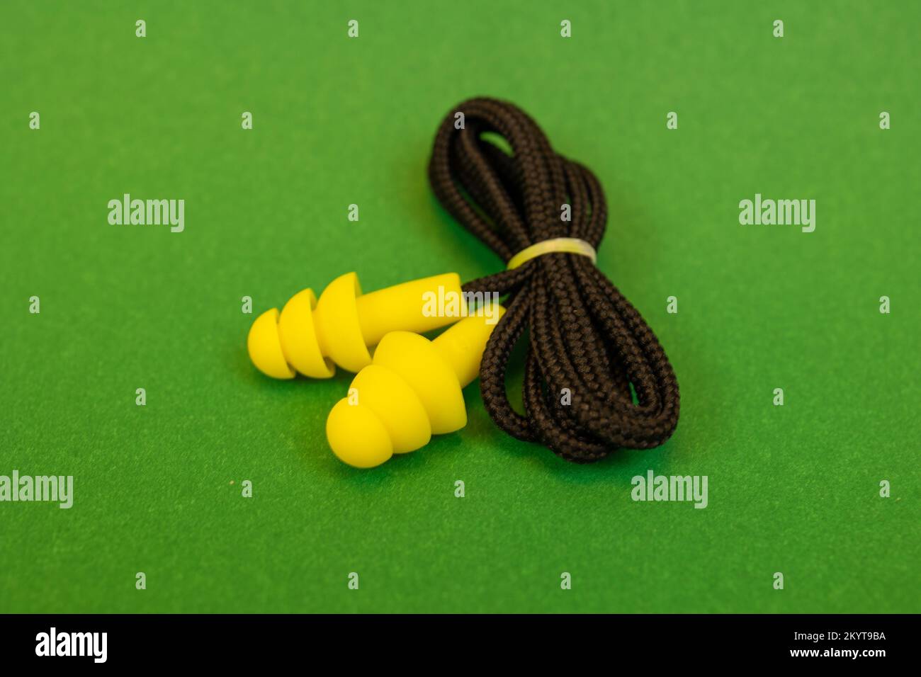 Silicone reusable ear plugs for human ears on green background Stock ...