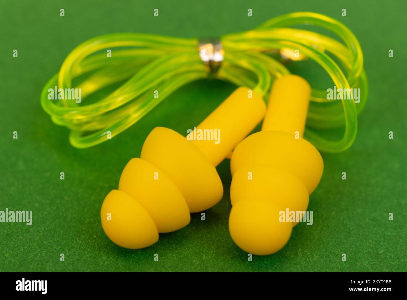 Silicone reusable ear plugs for human ears on green background Stock ...