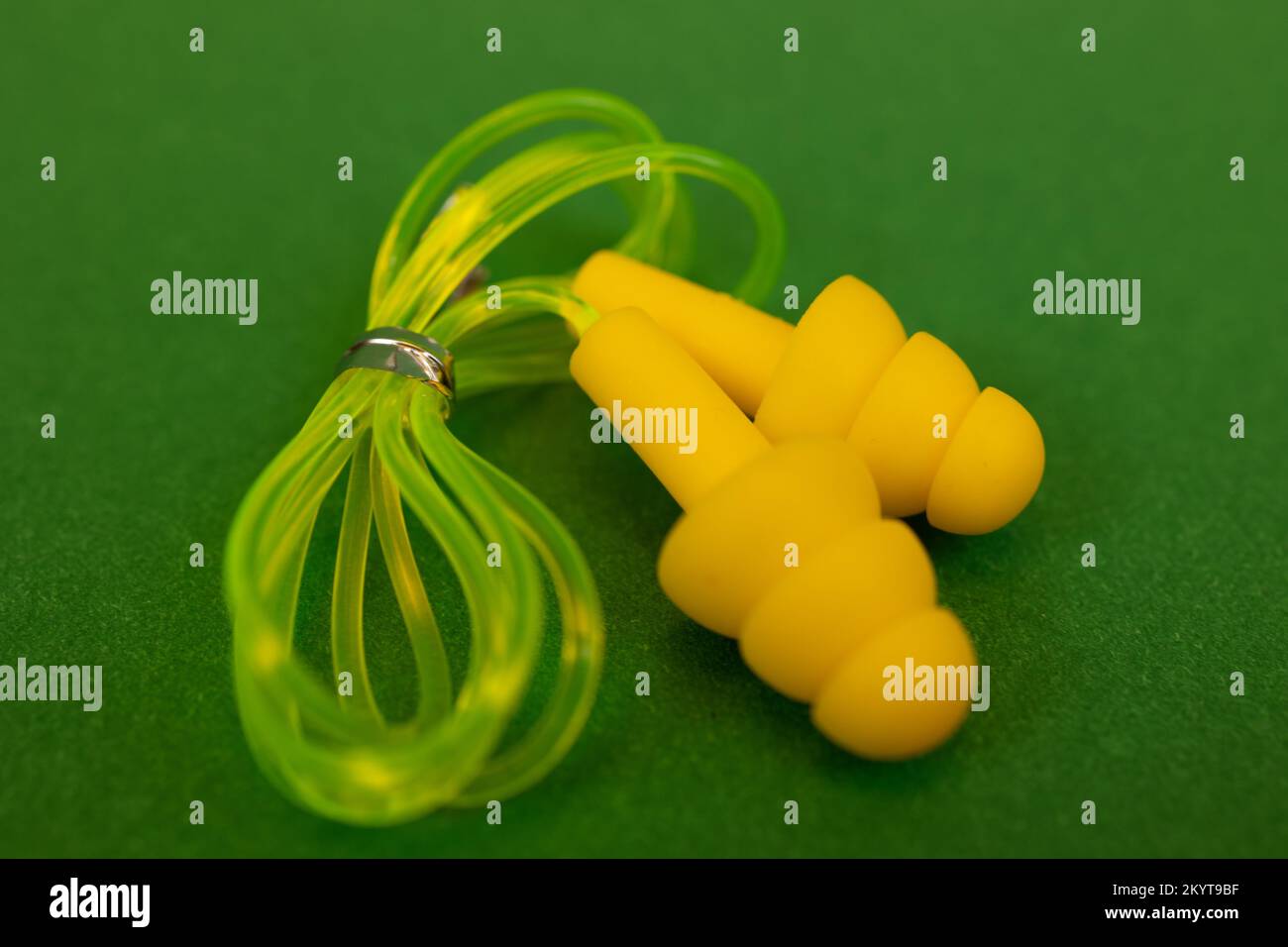 Silicone reusable ear plugs for human ears on green background Stock ...