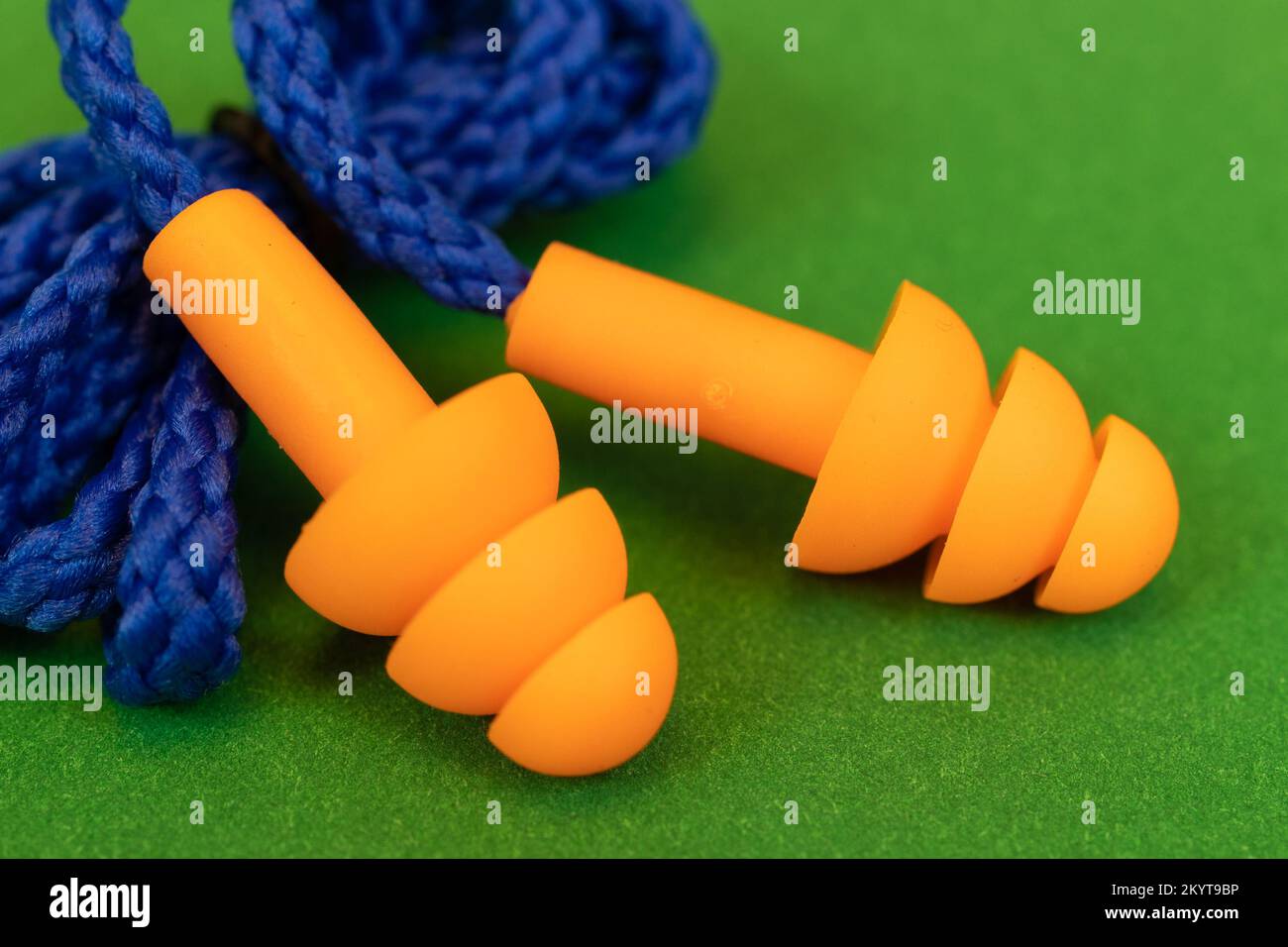 Silicone reusable ear plugs for human ears on green background Stock ...