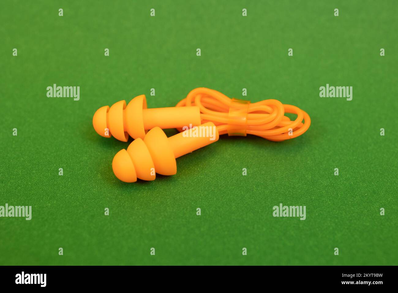 Silicone reusable ear plugs for human ears on green background Stock ...