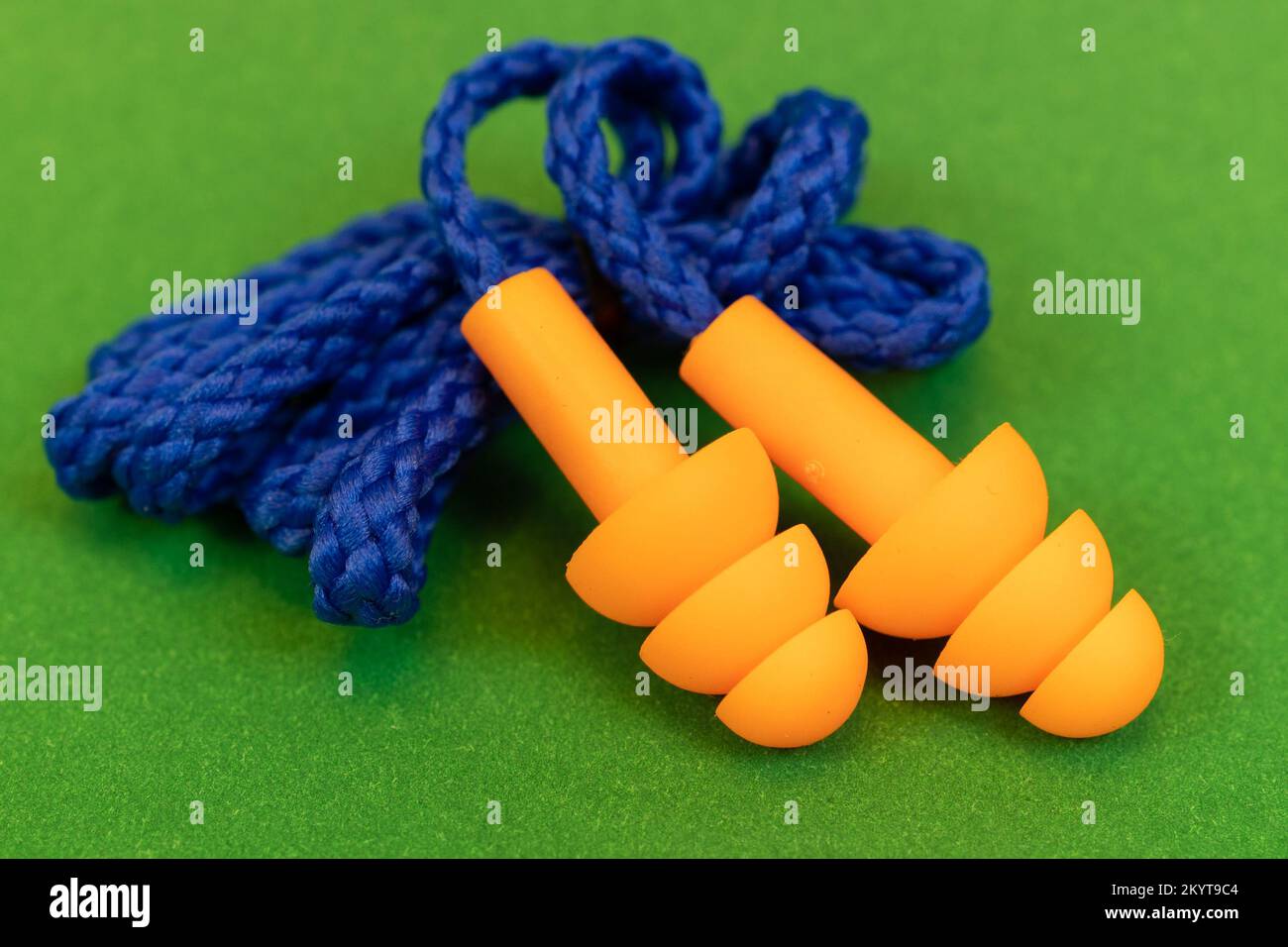 Silicone reusable ear plugs for human ears on green background Stock ...